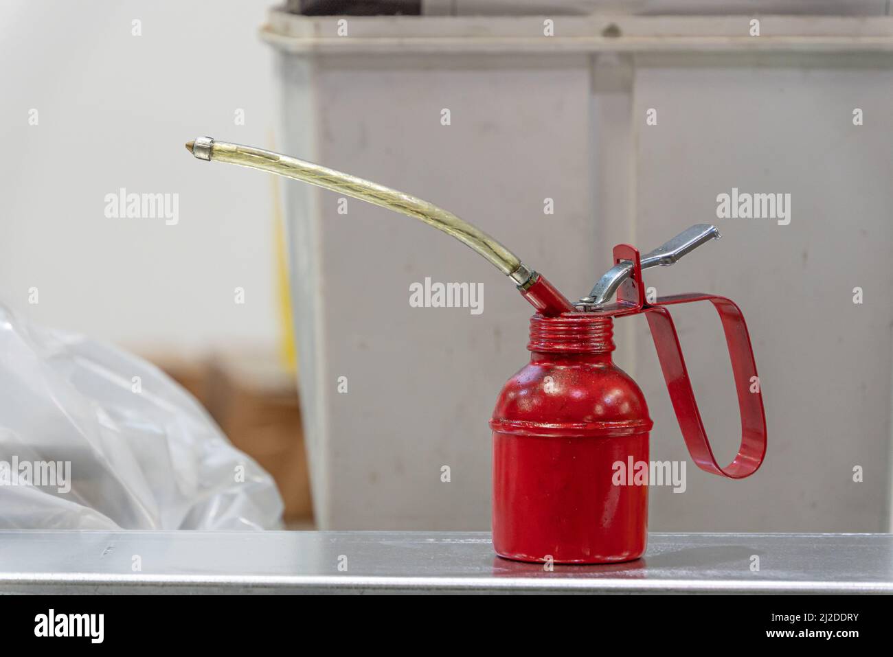 red metal oil can filled with oil and lubricant Stock Photo - Alamy