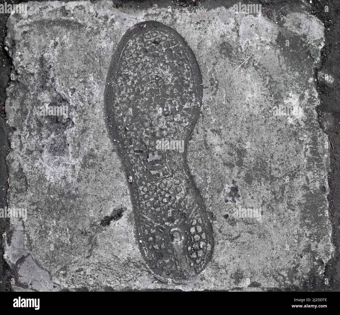 The old single imprint,footprint of shoe or boot on concrete with copy ...