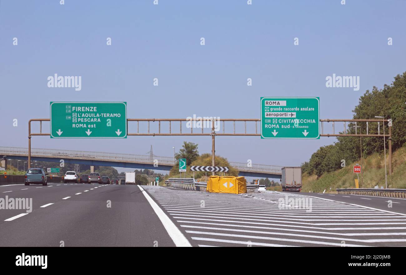 crossroads with large road sign in the highway with Italian locations ...