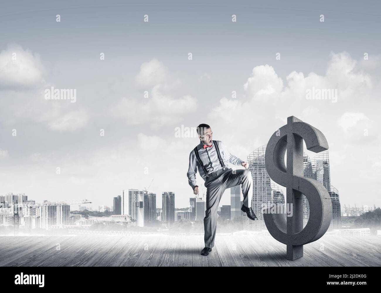 Determined banker man against modern cityscape breaking dollar cement ...