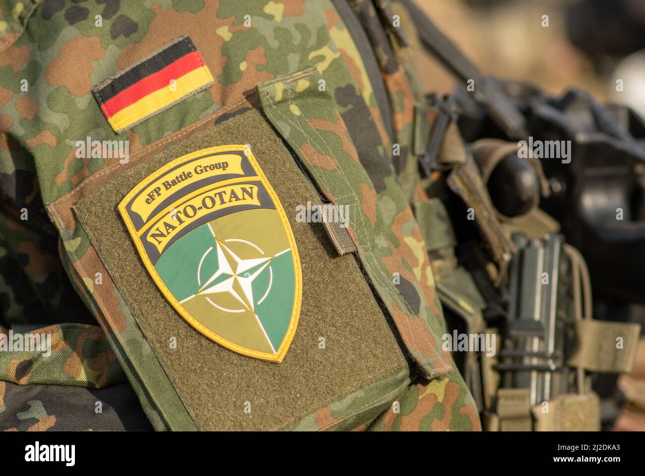 Flag of Germany and symbol of NATO battle group on a soldier uniform ...