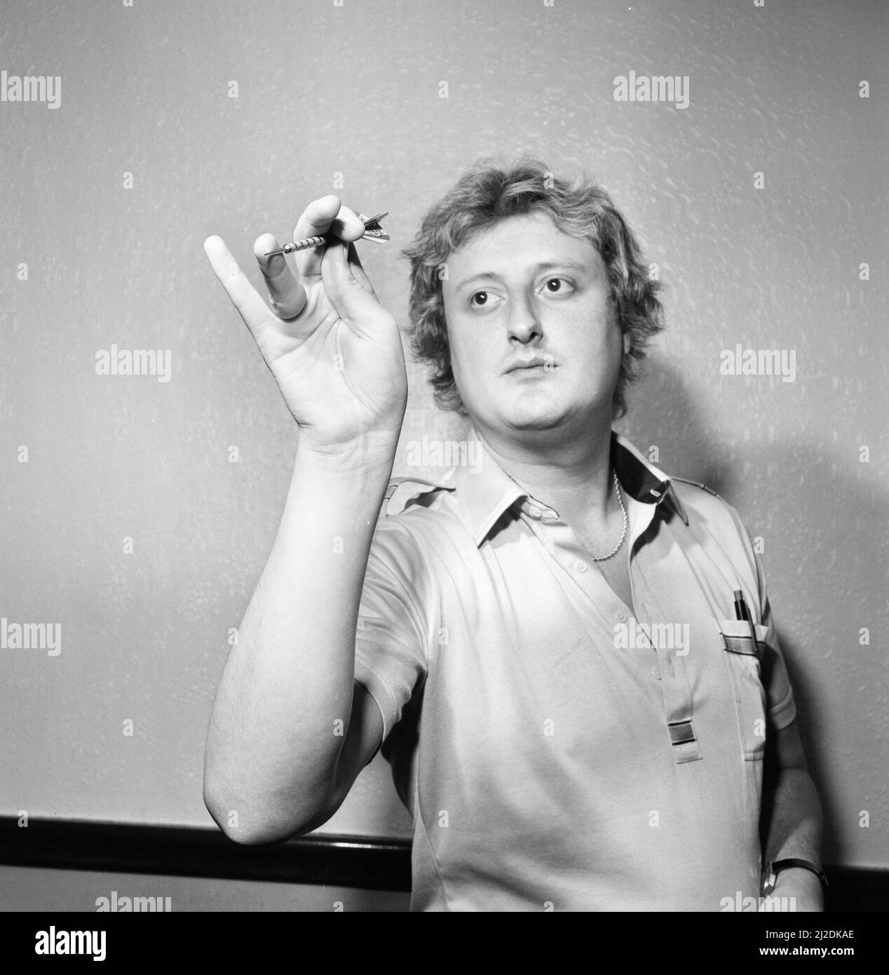 Close up feature on British darts player Eric Bristow in dart throwing ...