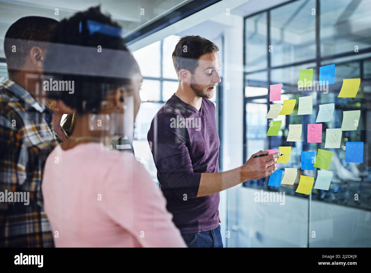 Dividing tasks between the team. Cropped shot of a team of designers ...