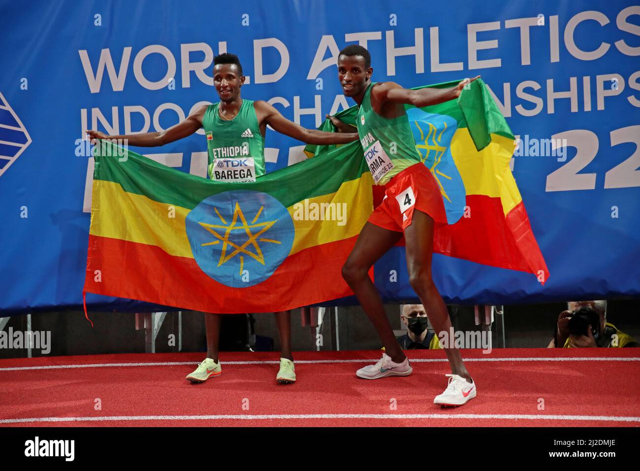 Selemon Barega (ETH) and Lamecha Girma (ETH) pose with Ethiopian flags ...