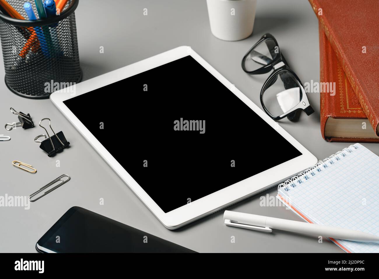 Digital tablet with empty screen on table with business accessories ...
