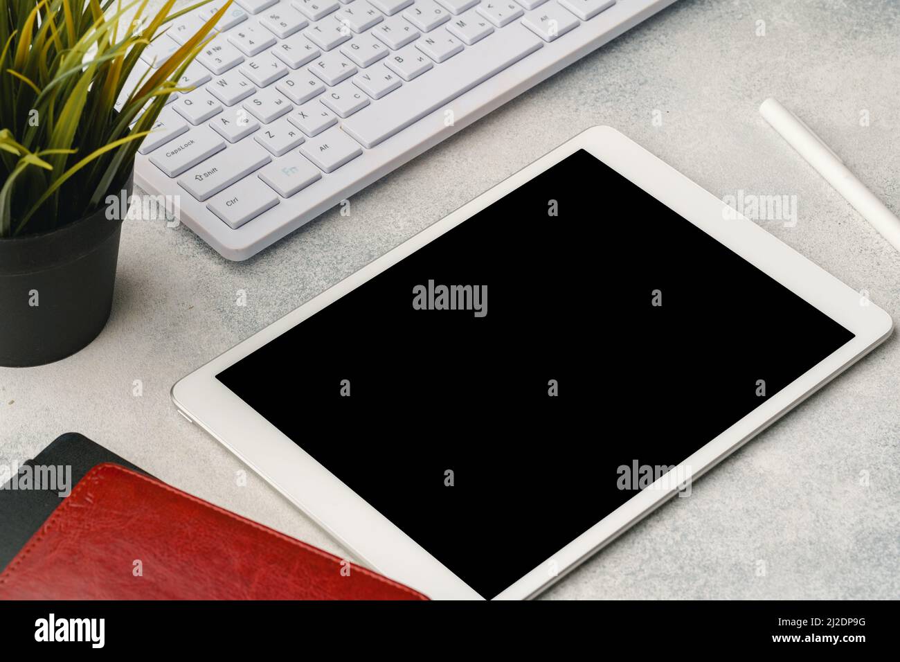 Digital tablet with empty screen on table with business accessories ...