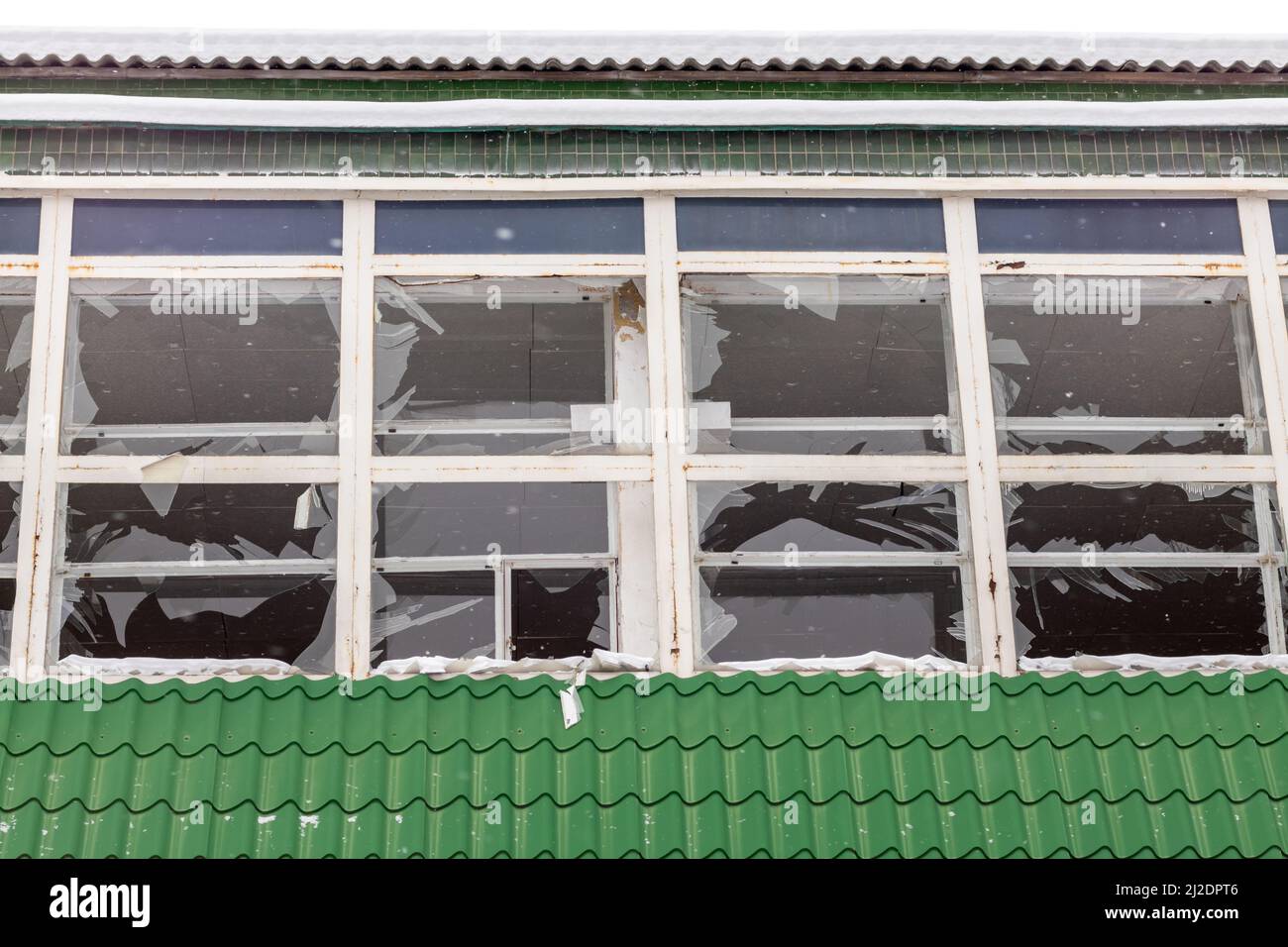 Many broken windows on the brick wall of the building after the ...