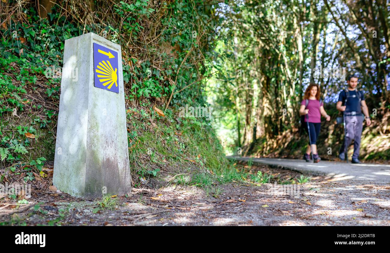 Signpost of Saint James way with pilgrims walking Stock Photo - Alamy