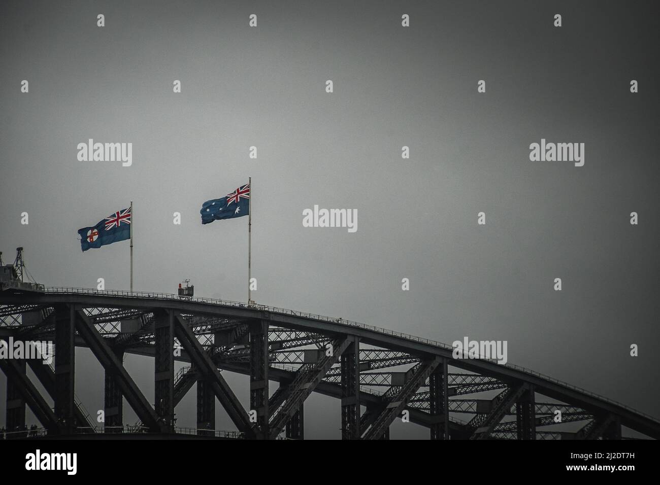 The Sydney Harbour Bridge with Australian flags on it under the ...