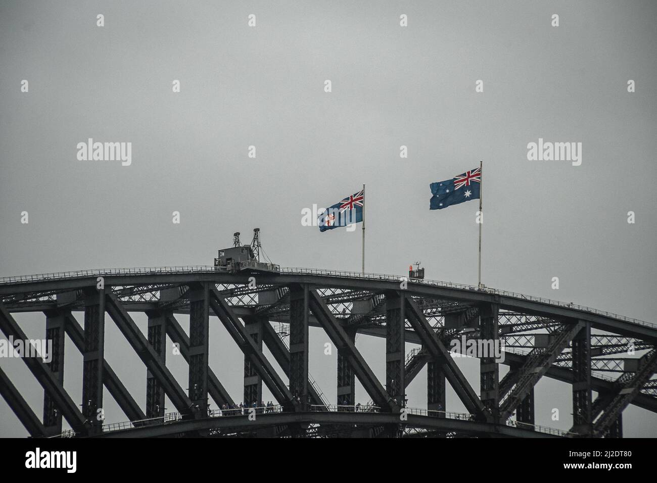 The Sydney Harbour Bridge with Australian flags on it under the ...