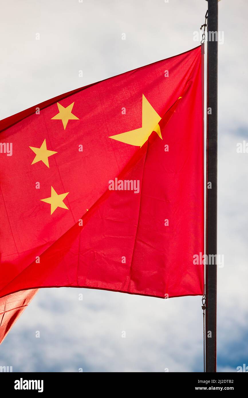 China flag waving over a blue sky. Chinese national emblem Stock Photo ...