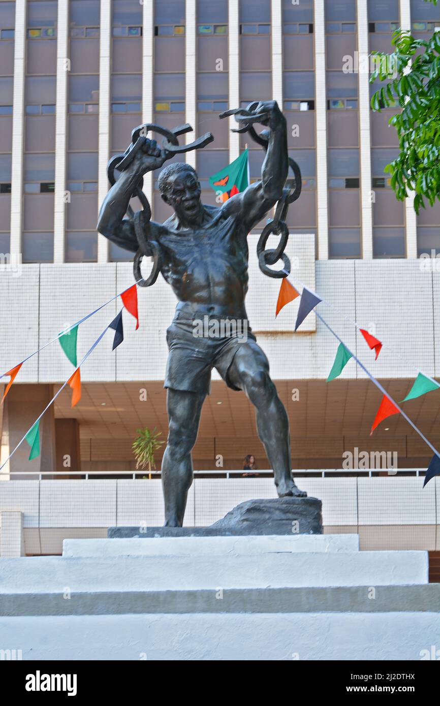 A vertical shot of the Zambian Freedom statue with triangle string flag ...