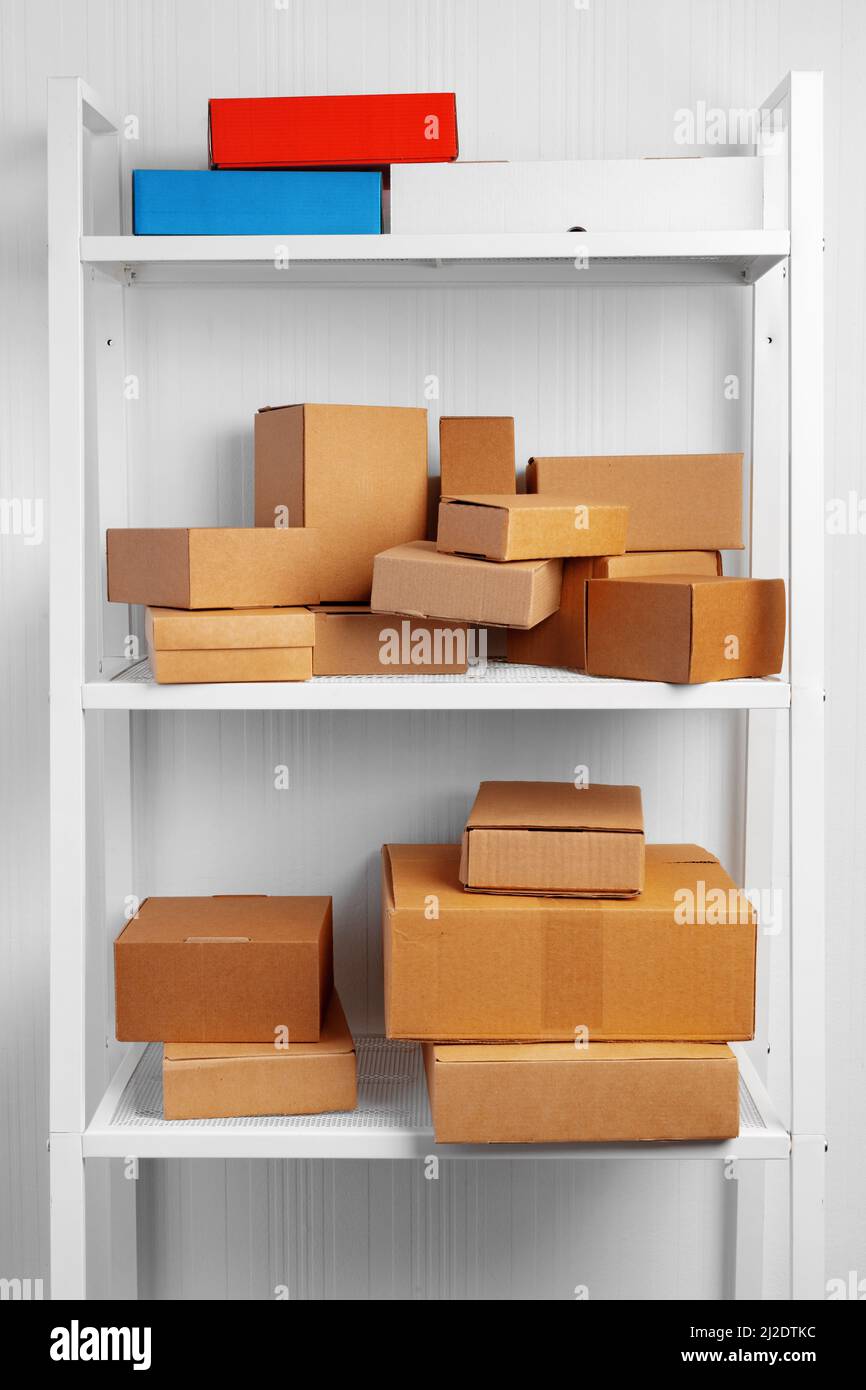 Stack of cardboard package boxes on wooden rack Stock Photo - Alamy