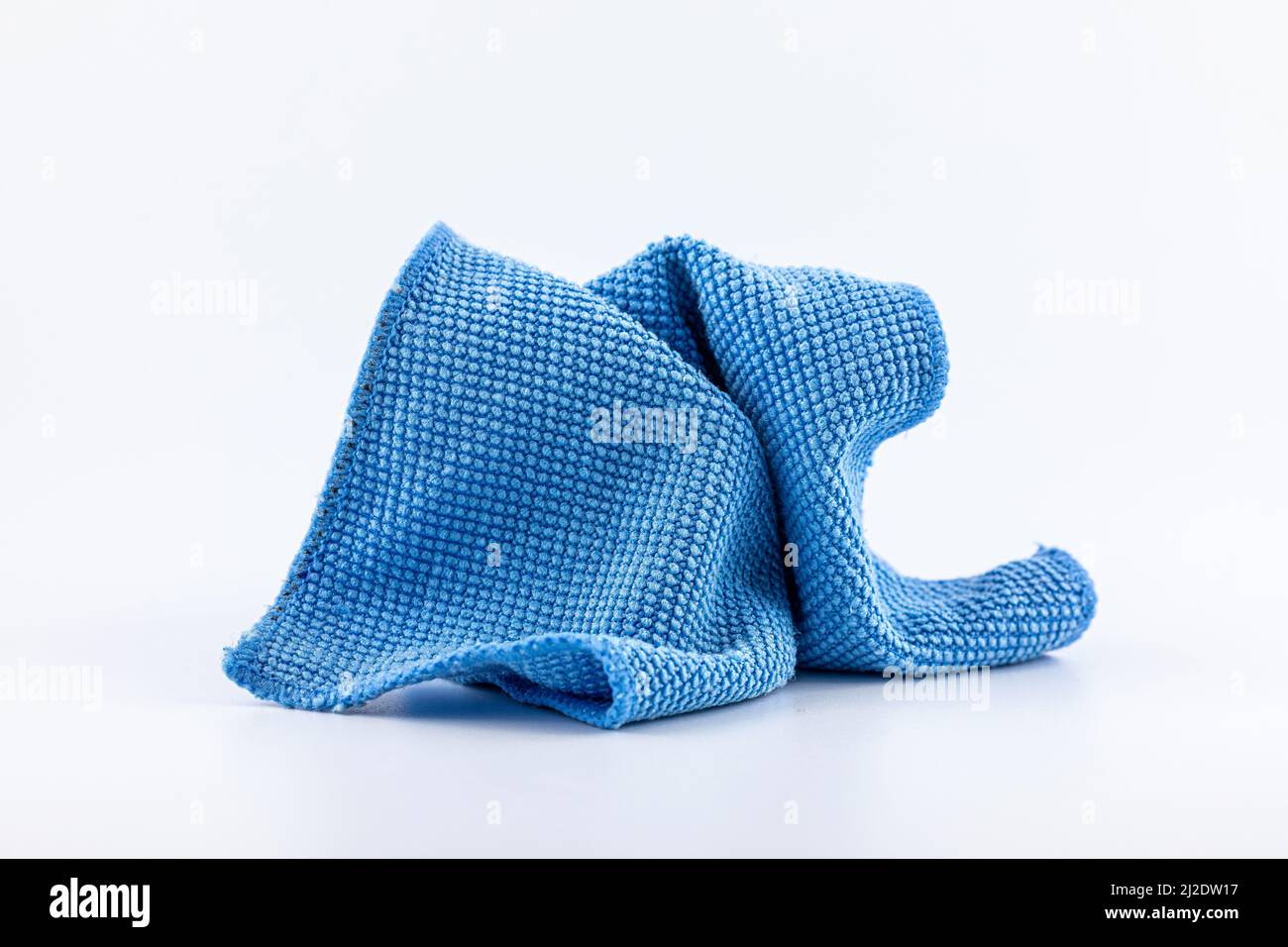 Blue microfiber fabric with rough texture for cleaning dust isolated on ...