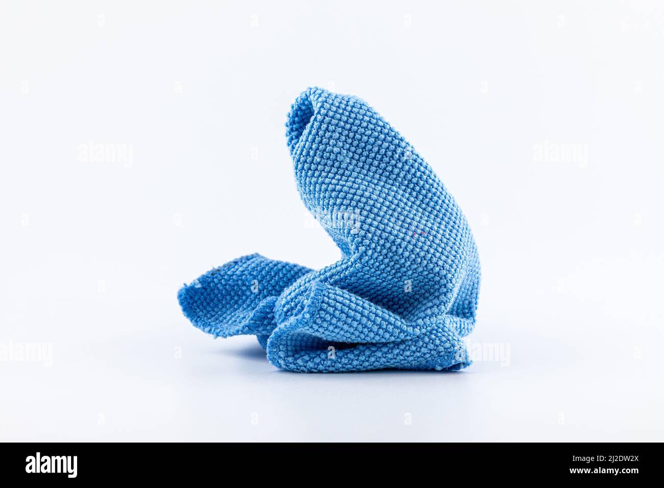 Blue microfiber fabric with rough texture for cleaning dust isolated on ...