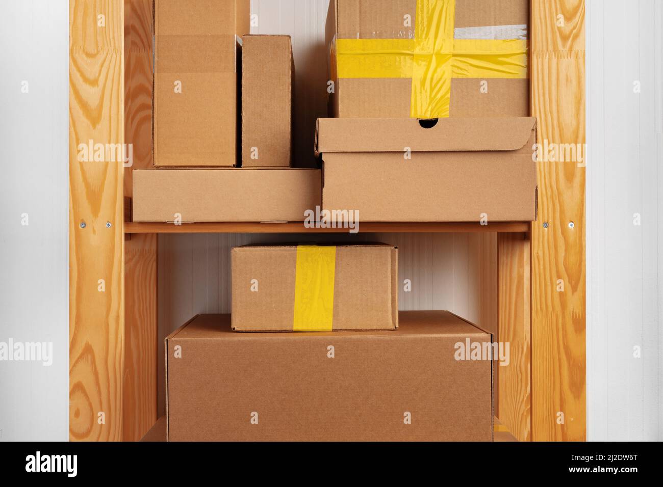 Stack of cardboard package boxes on wooden rack Stock Photo - Alamy