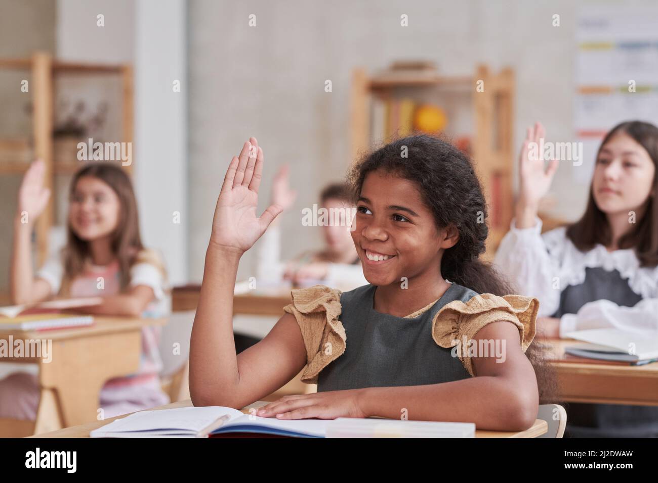 African american girl raising hand hi-res stock photography and images ...