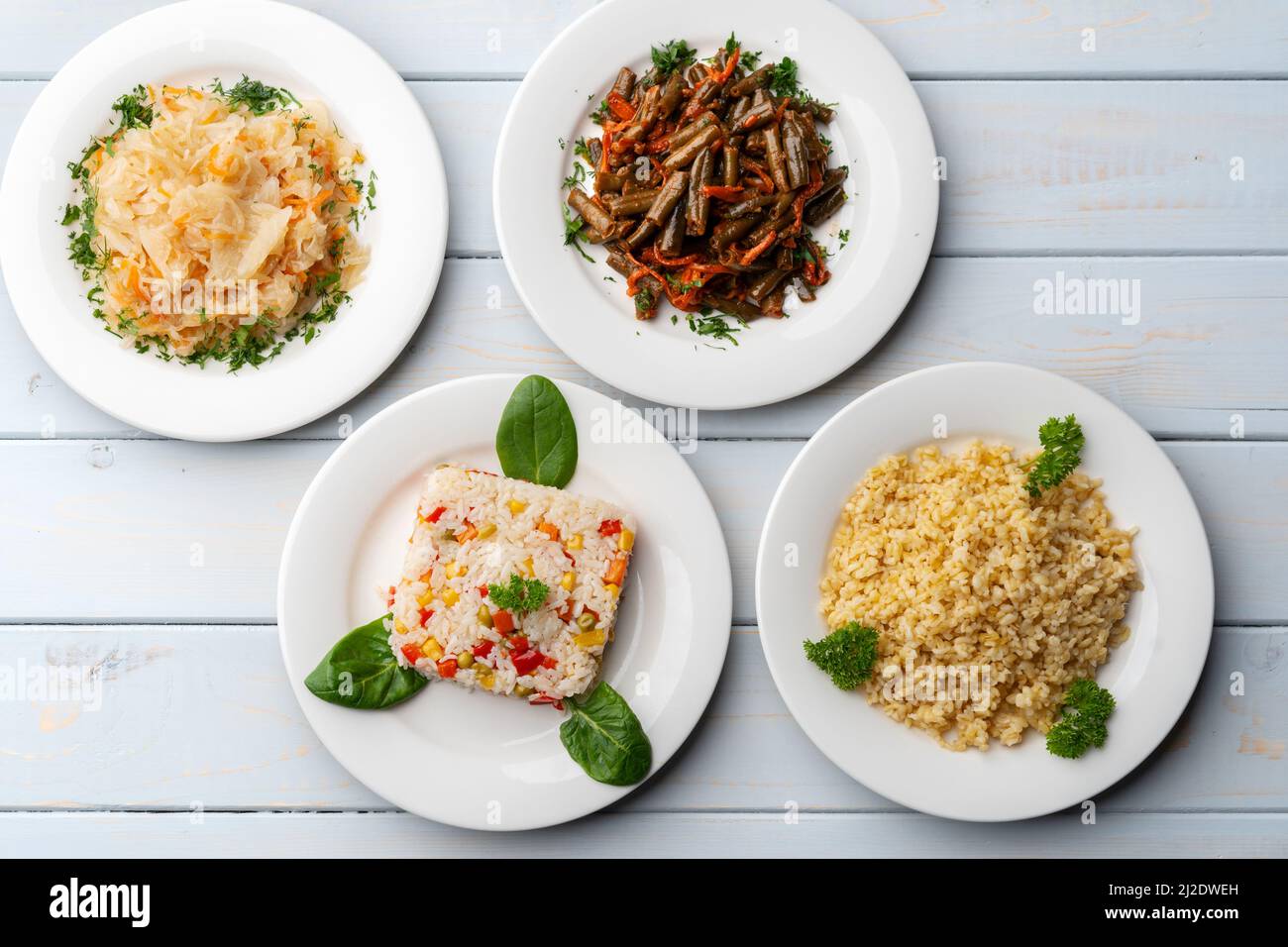 Variety of garnishes like cooked rice, bulgur, stewed cabbage and green ...