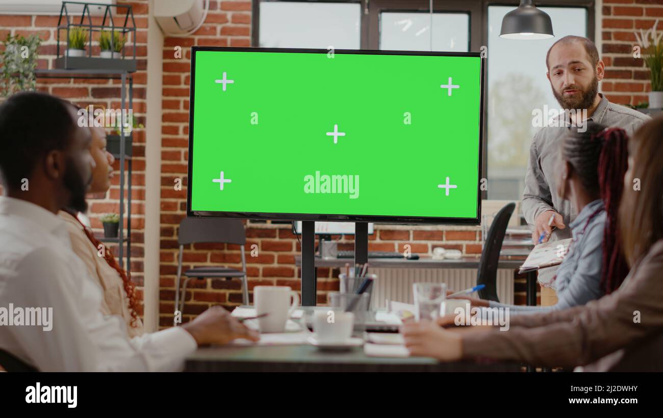 Man doing presentation with isolated green screen on display in ...