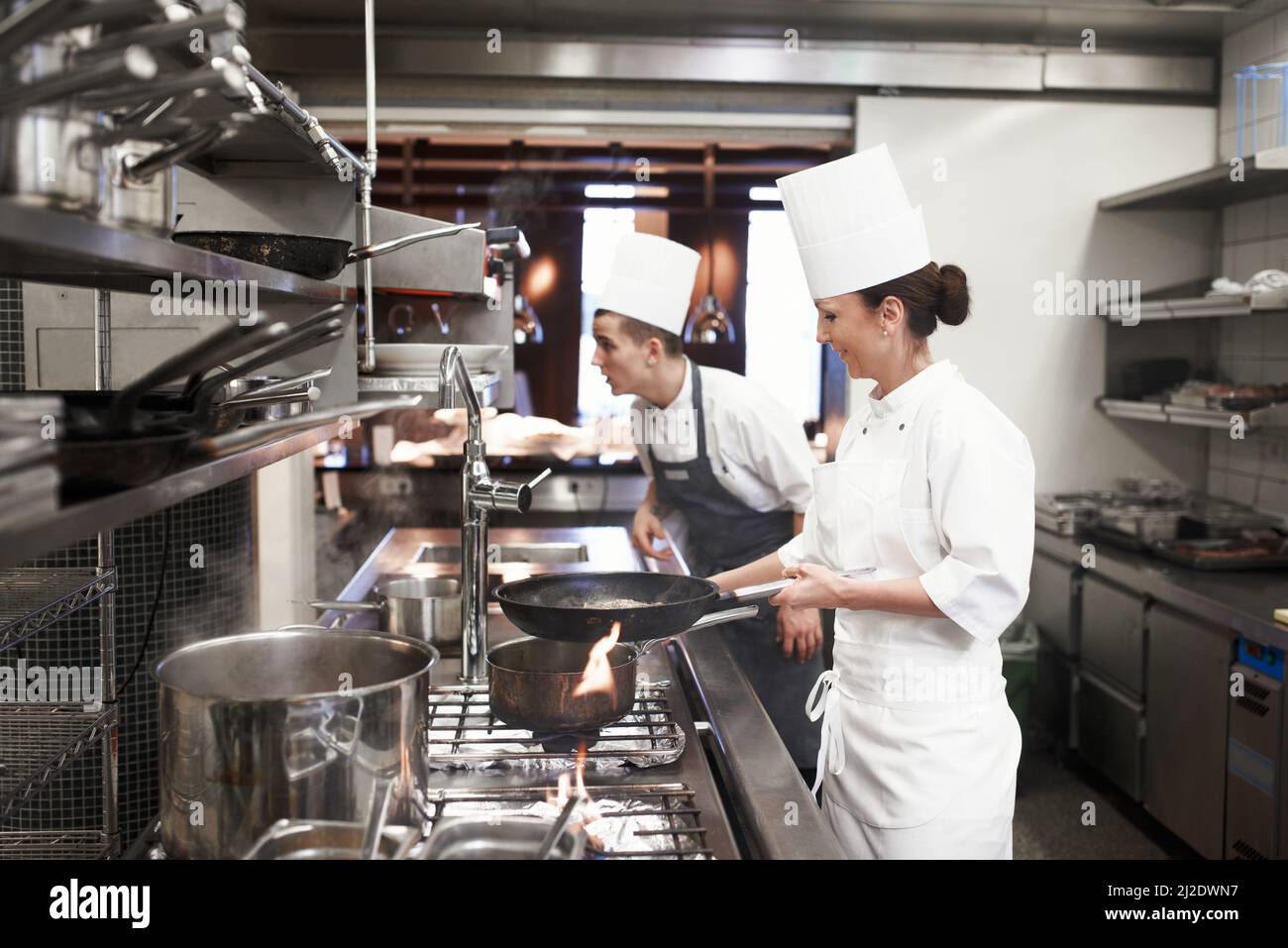 Cook with passion. Shot of the inner working of a professional kitchen ...