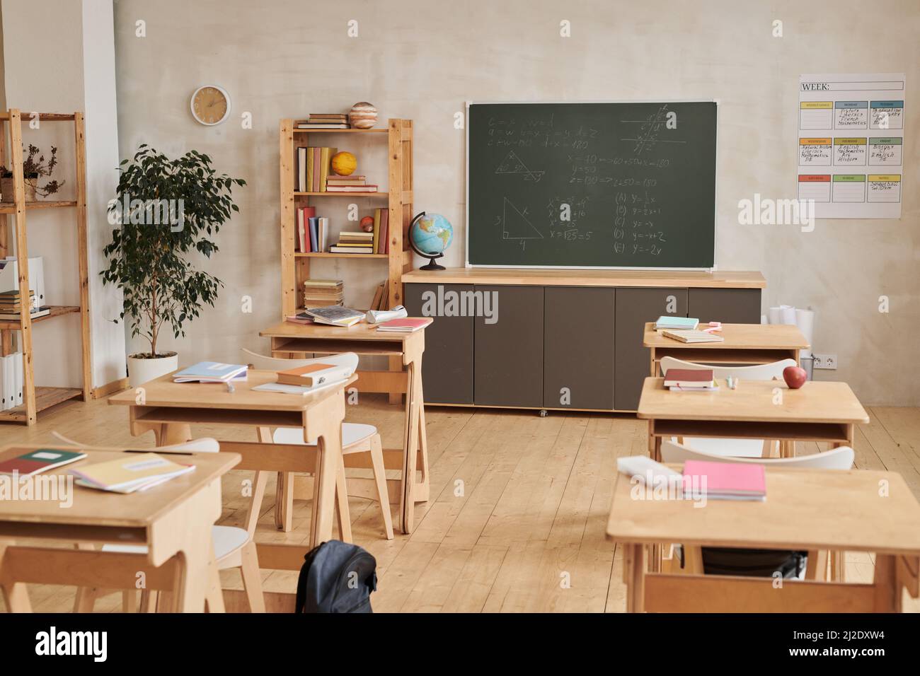 Background image of empty school classroom with wooden desks in row ...