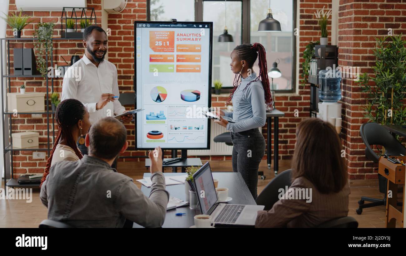 Business people receiving applause and presenting financial project ...