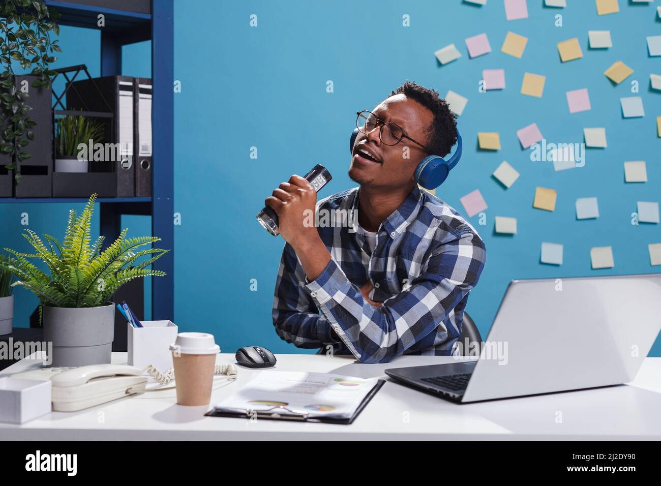 Cheerful smiling heartily young office worker wearing wireless ...