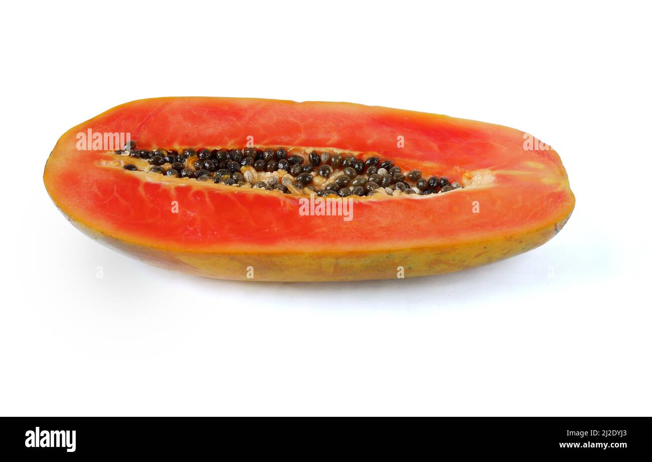 A closeup of half cut ripe papaya fruit isolated on white background ...