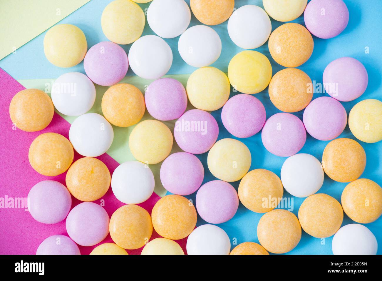 A top view of pastel colored candies on the colorful background Stock ...