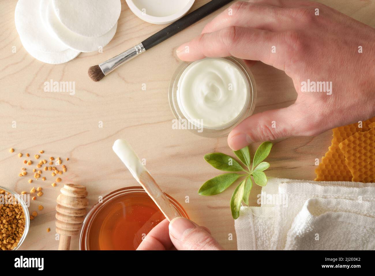 Moisturizing skin care cream with honey extracts with pot and plate ...