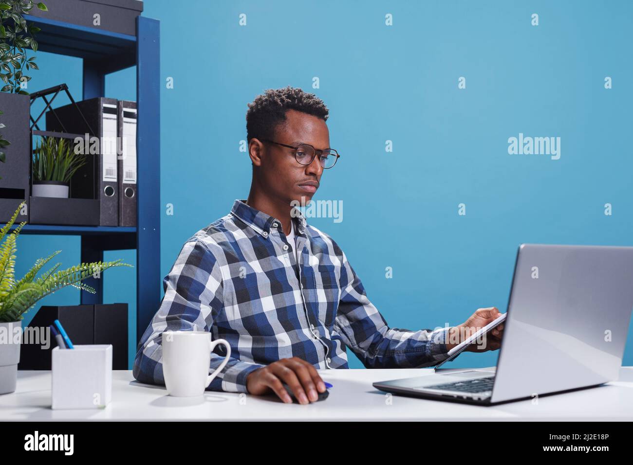Confident company employee using work computer to analyze accounting ...