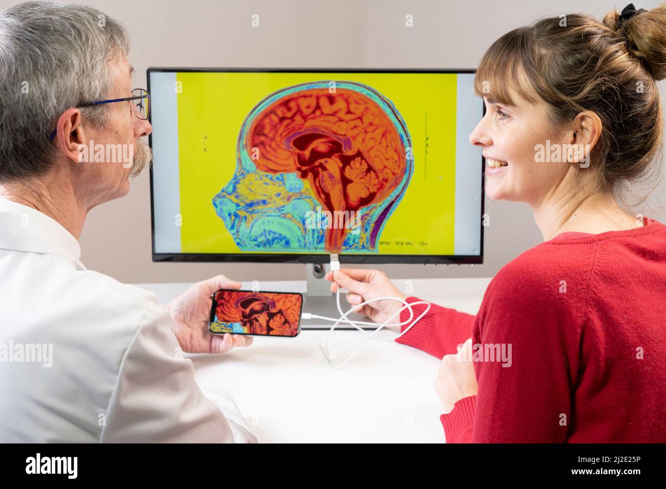 Smartphone connected to the brain Stock Photo - Alamy
