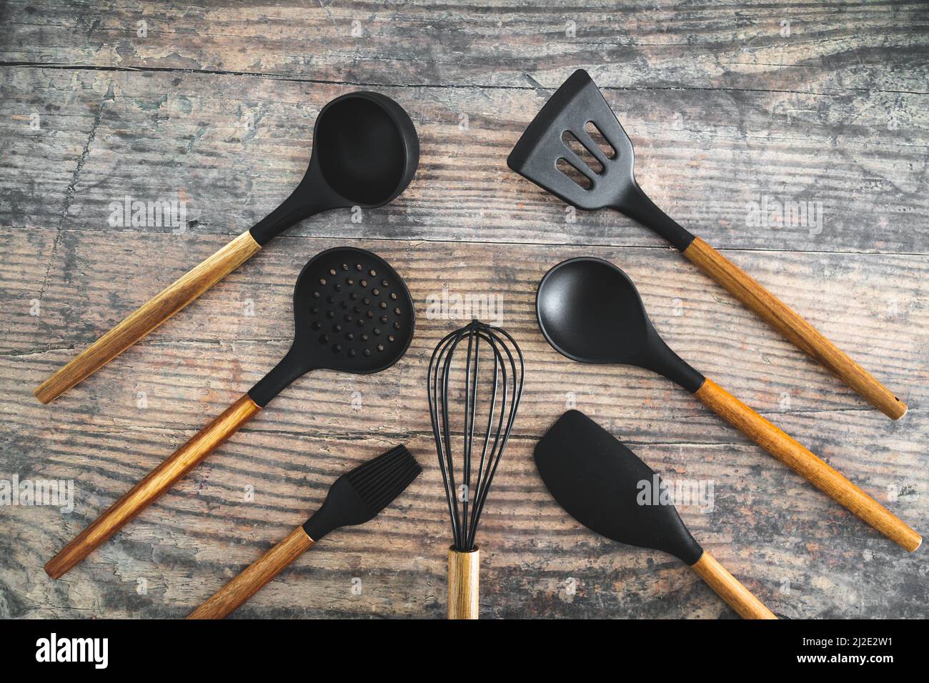 set of matching wooden and silicone kitchen utensils, concept of ...