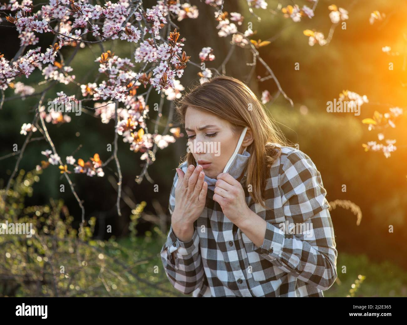 Young girl puts a mask on her face after she had reaction and started ...