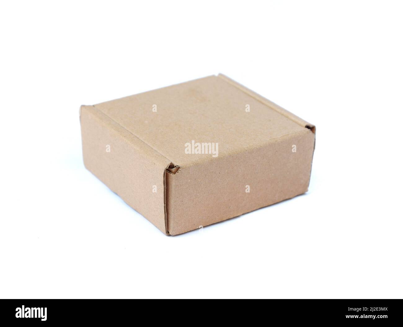 A closeup side view of a cardboard box isolated on white background ...