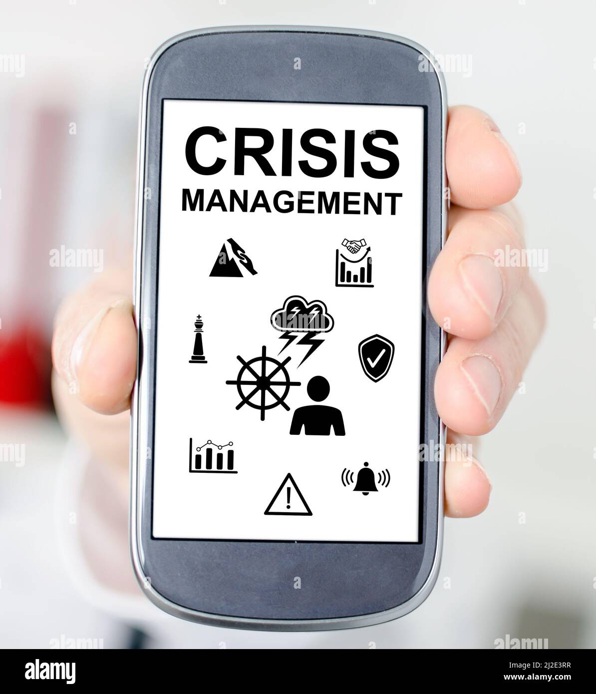 Hand holding a smartphone with crisis management concept Stock Photo ...