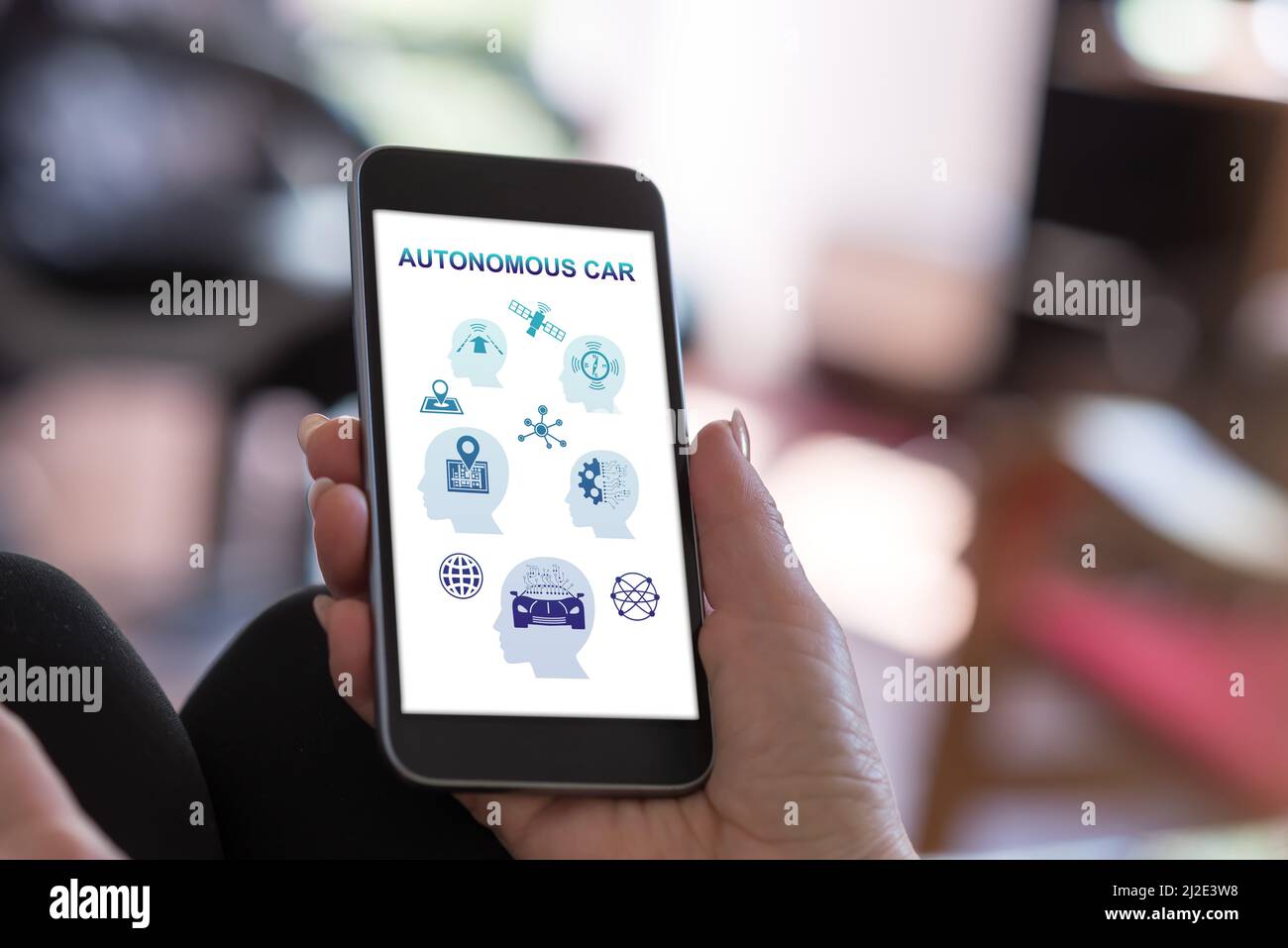 Hand holding a smartphone with autonomous car concept Stock Photo - Alamy