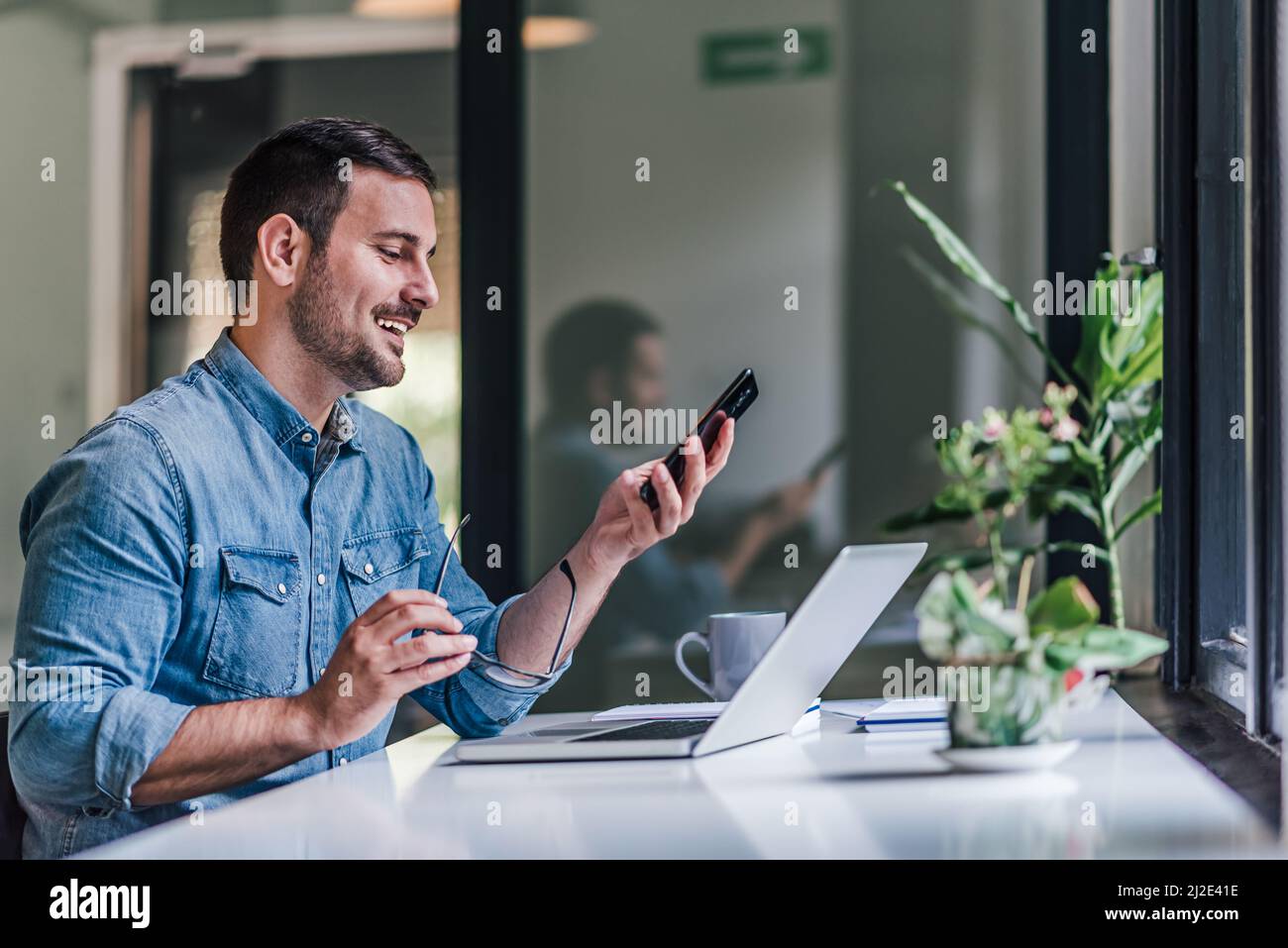 Calm adult man, trying to contact his coworker, over the phone Stock ...