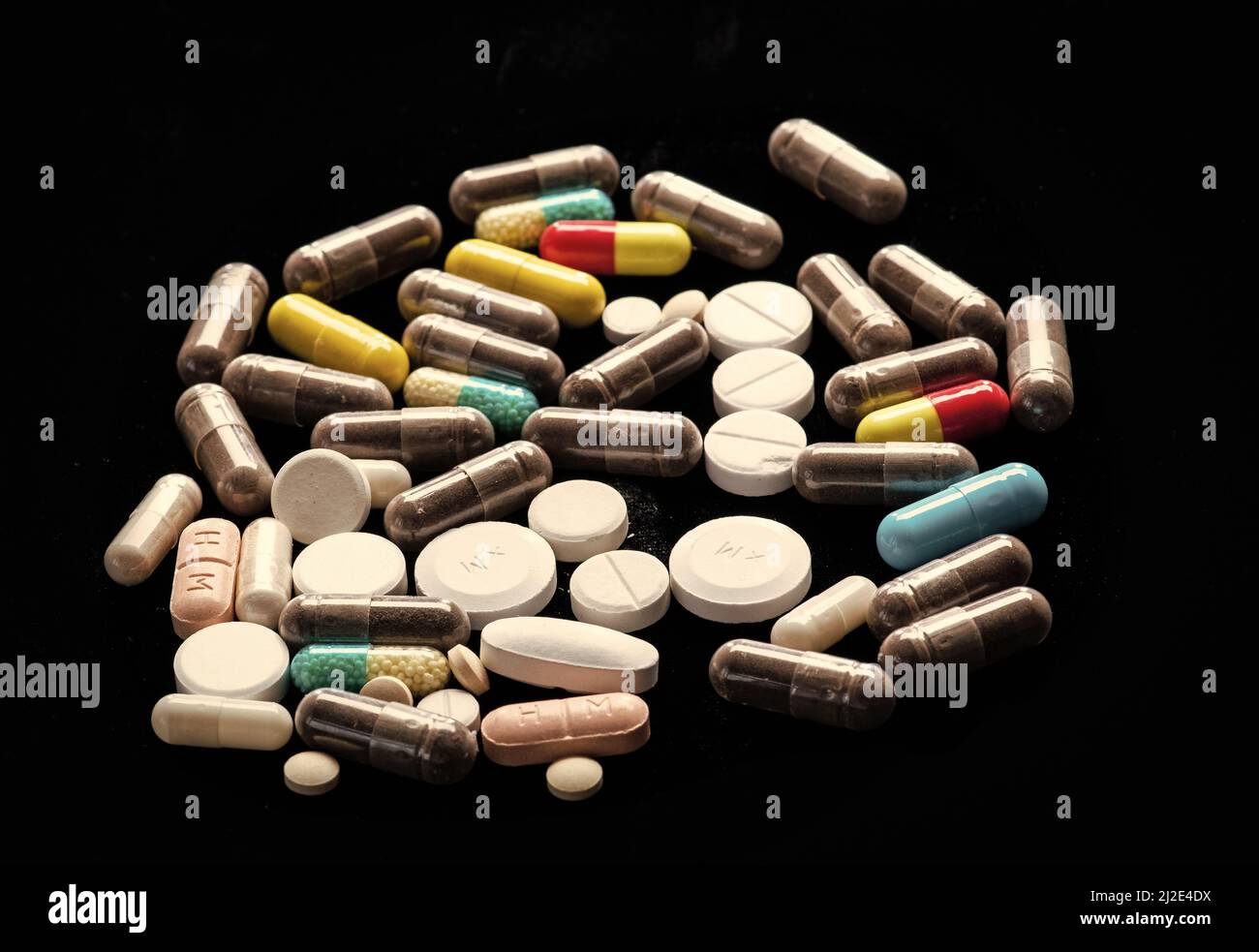 Pharmacy. Capsules and tablets dark background. Pharmacy products ...