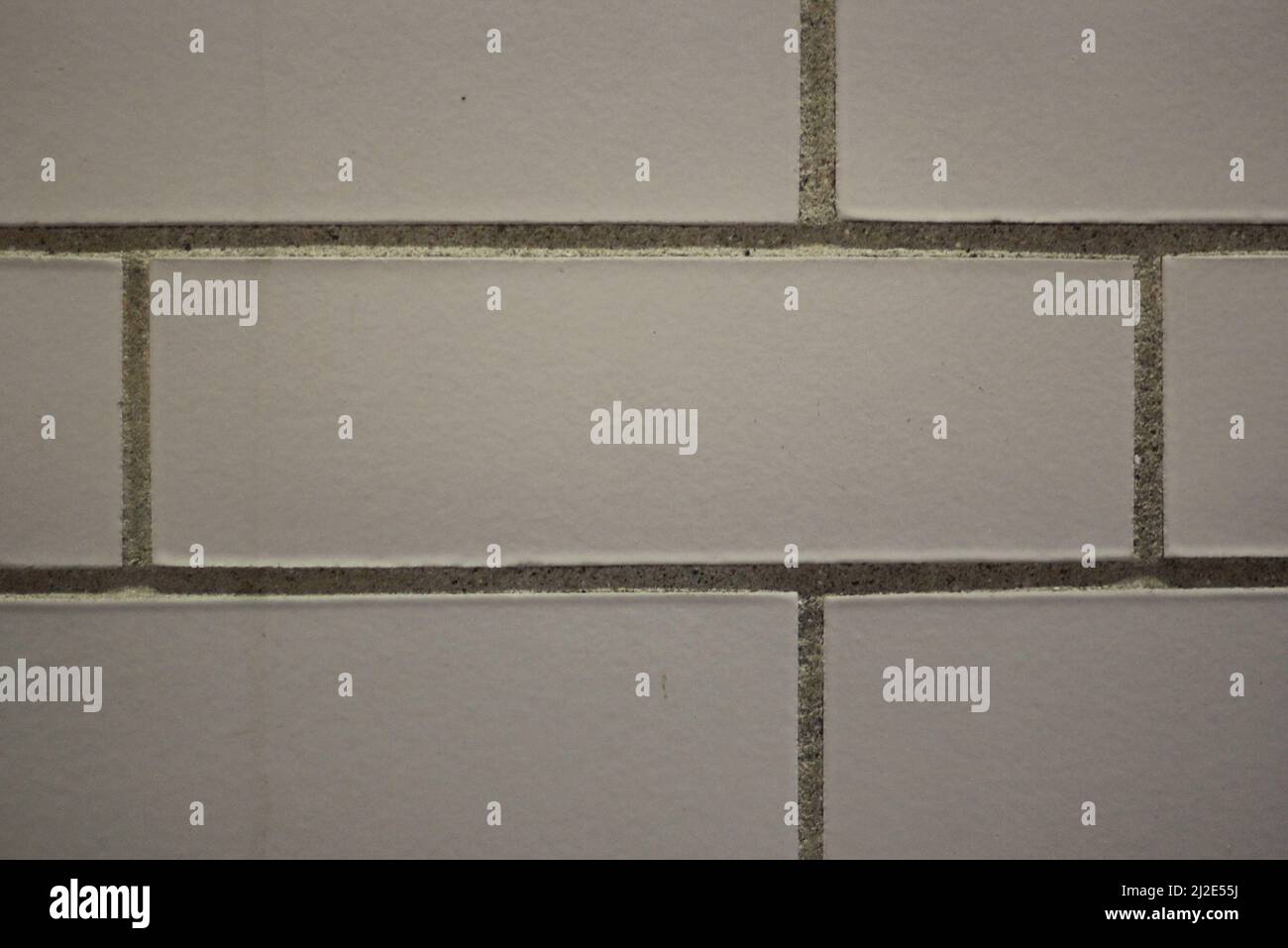 Horizontal subway tiles lining the basement of the public train station ...