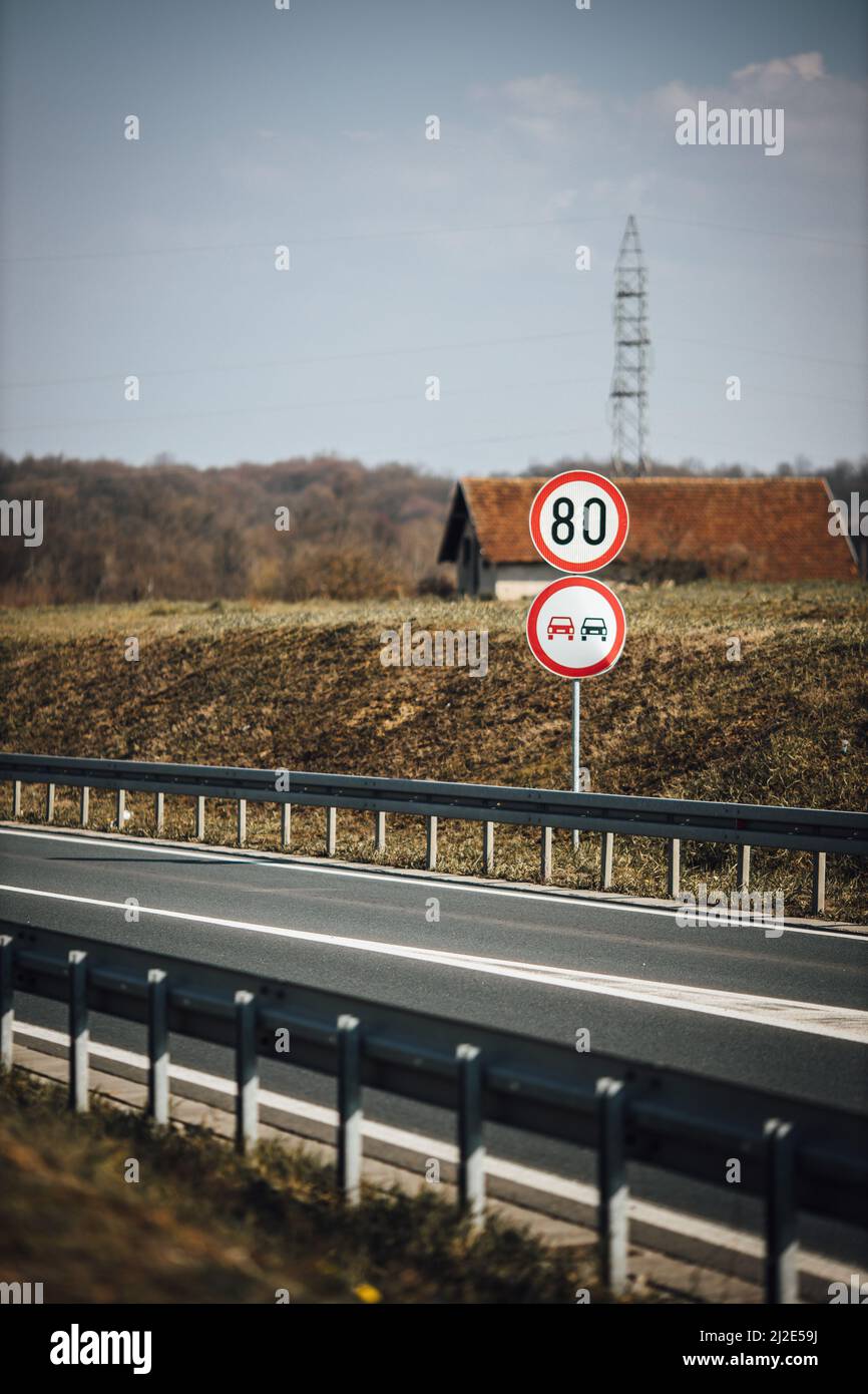 A vertical shot of two road signs Stock Photo - Alamy