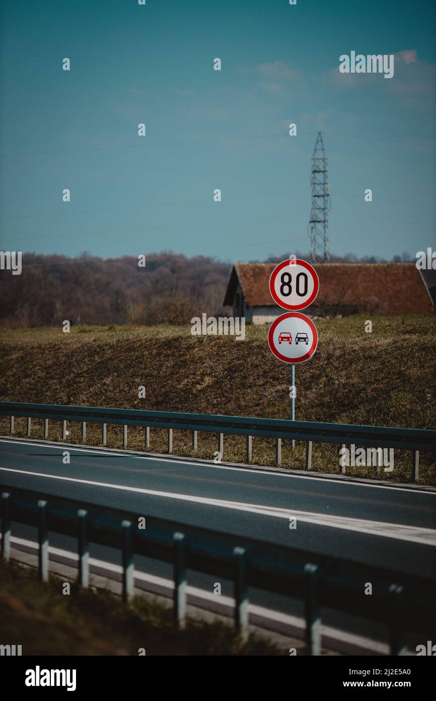 A vertical shot of two road signs Stock Photo - Alamy