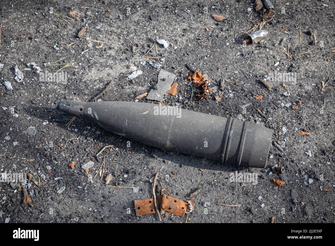 Artillery warhead lying on the ground on the driveway to the town of ...