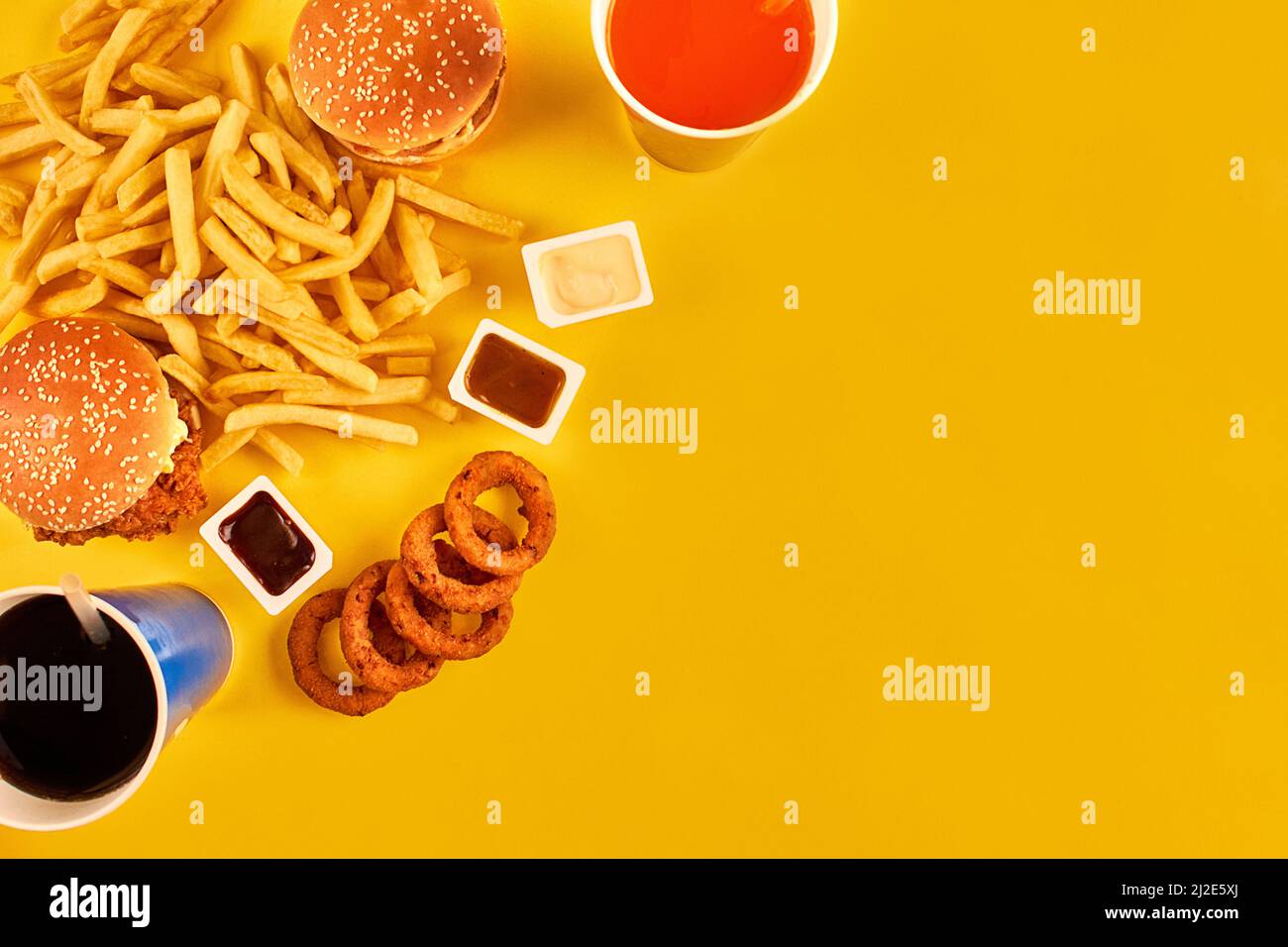 Fast food concept with greasy fried restaurant take out as onion rings ...