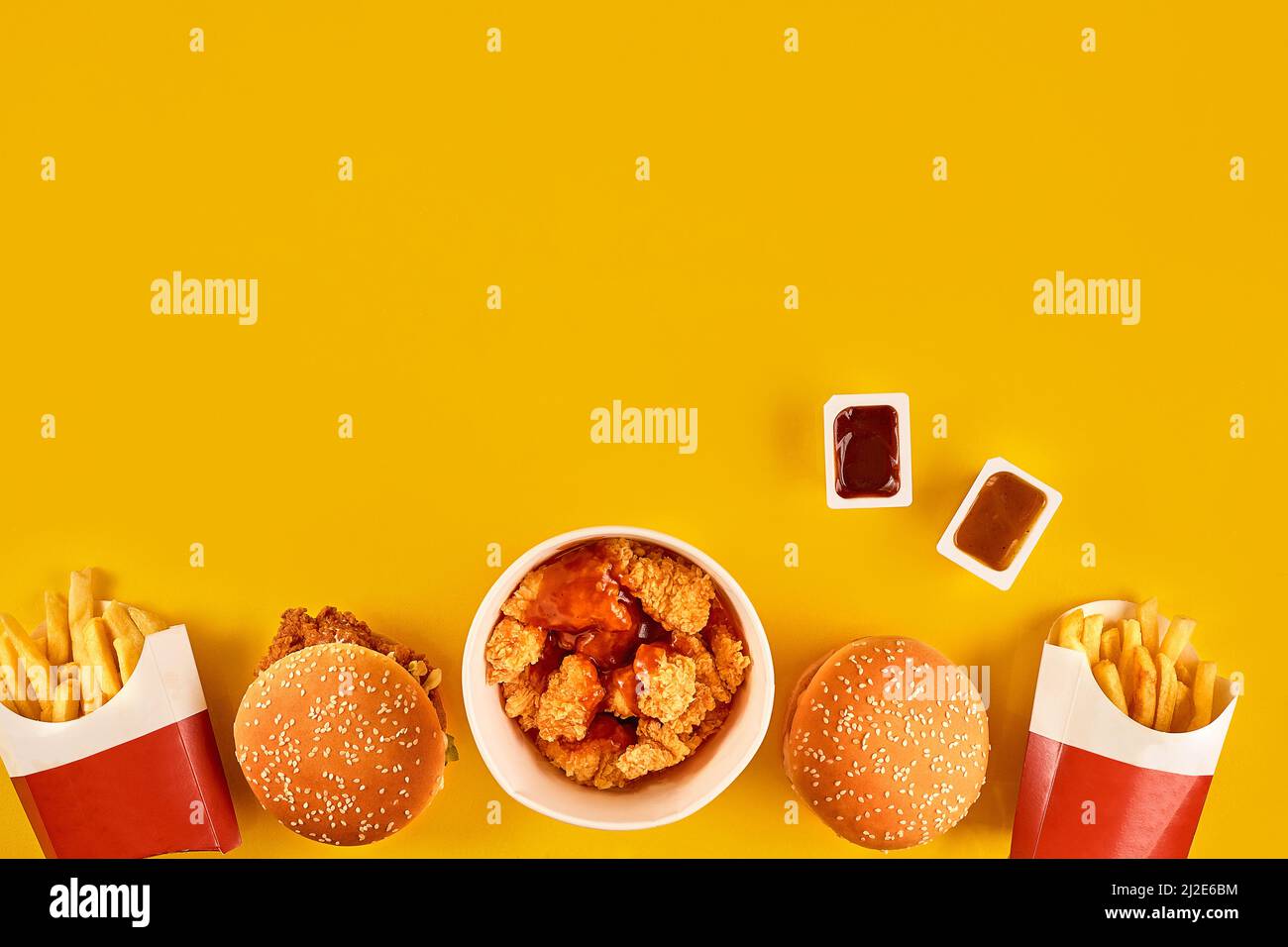 Fast food dish top view. Meat burger, potato chips and wedges. Take ...