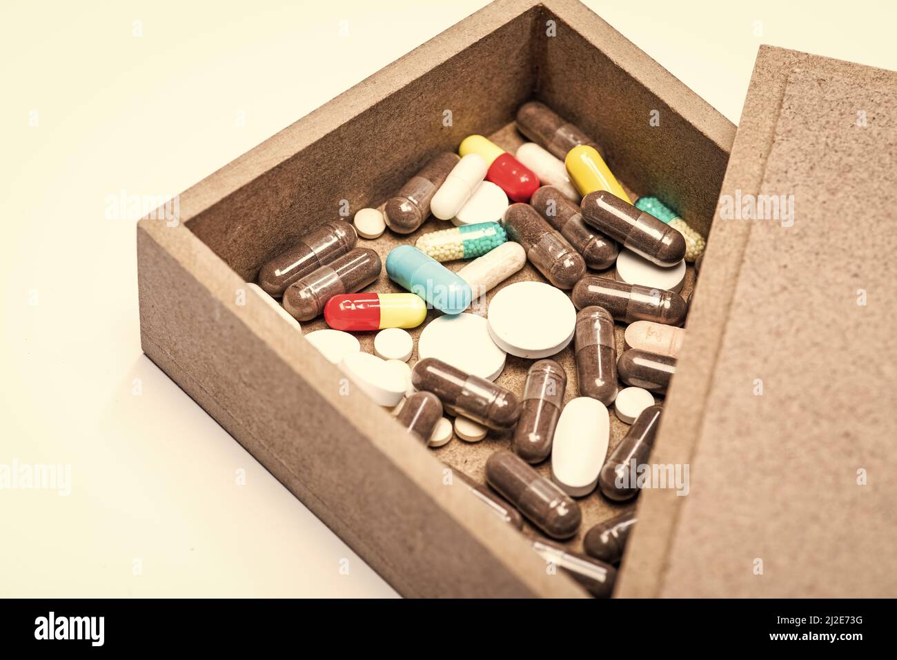 Prescription drugs of different shape and color in open pill box ...