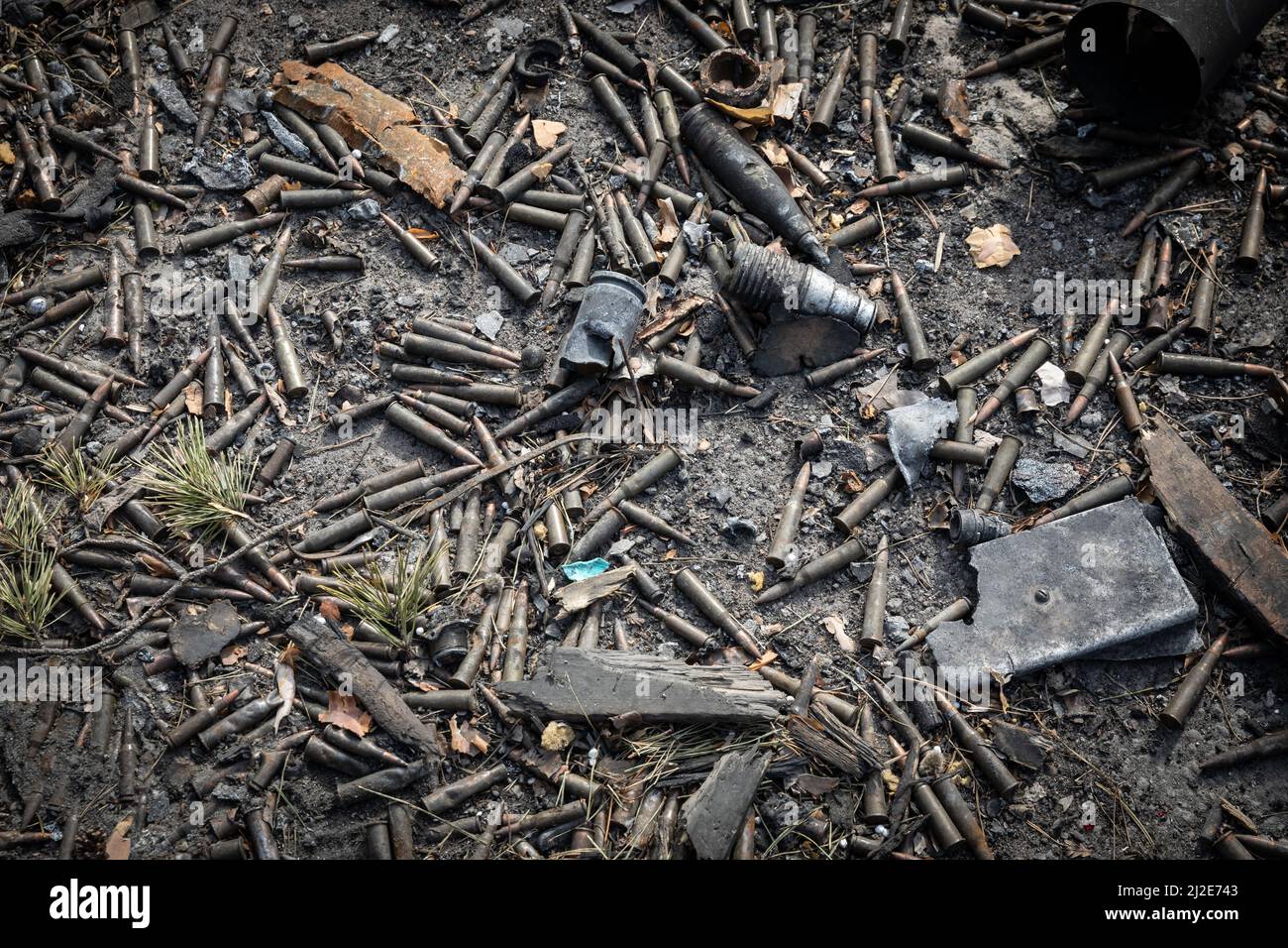 Ammunition and ammunition lying on the road next to an exploded tank ...