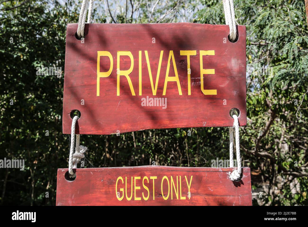 Sign saying Private and Guests Only on a wooden rustic board written in ...