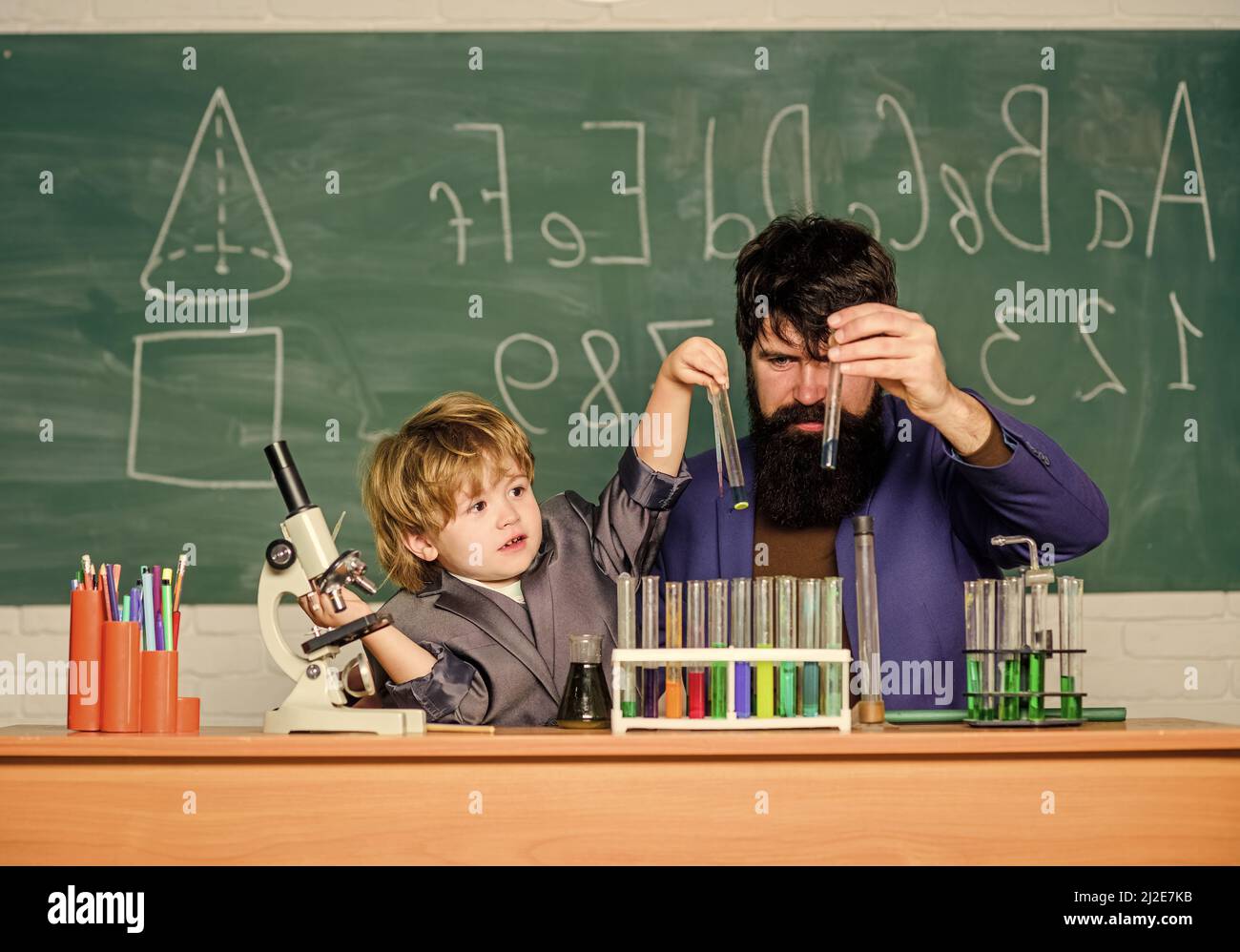 Teacher and pupil boy in chemical laboratory. Invent medicines ...