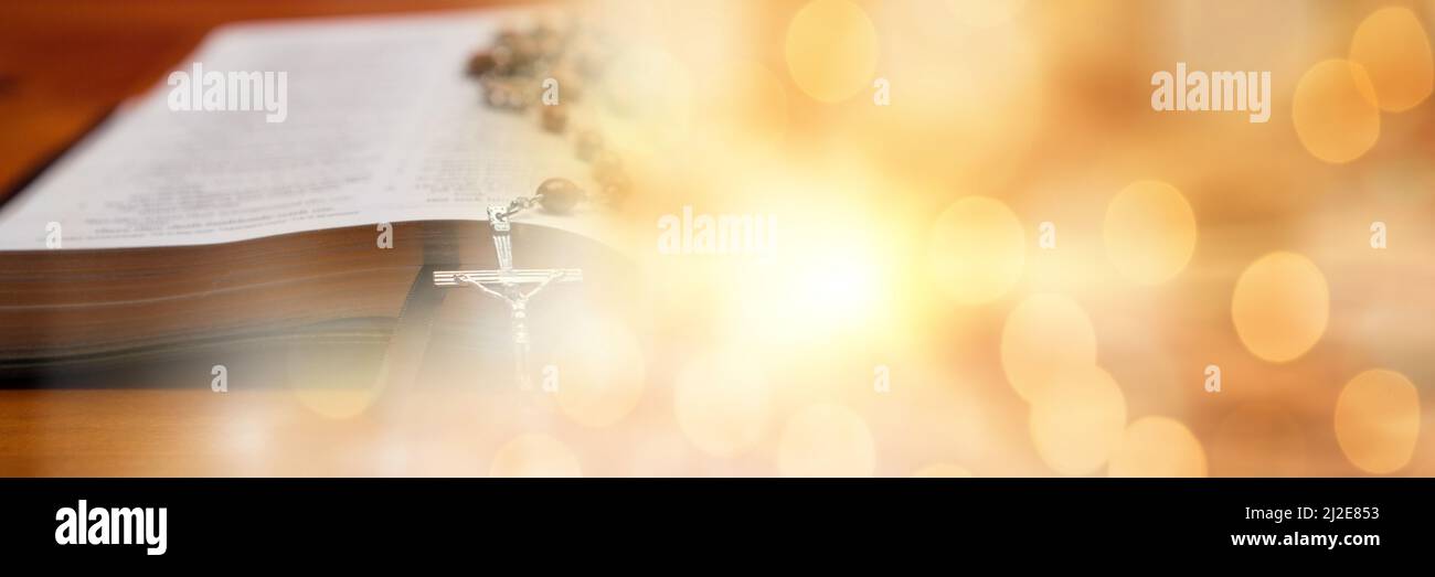 Blur effect with copy space against close up of a rosary over a holy ...